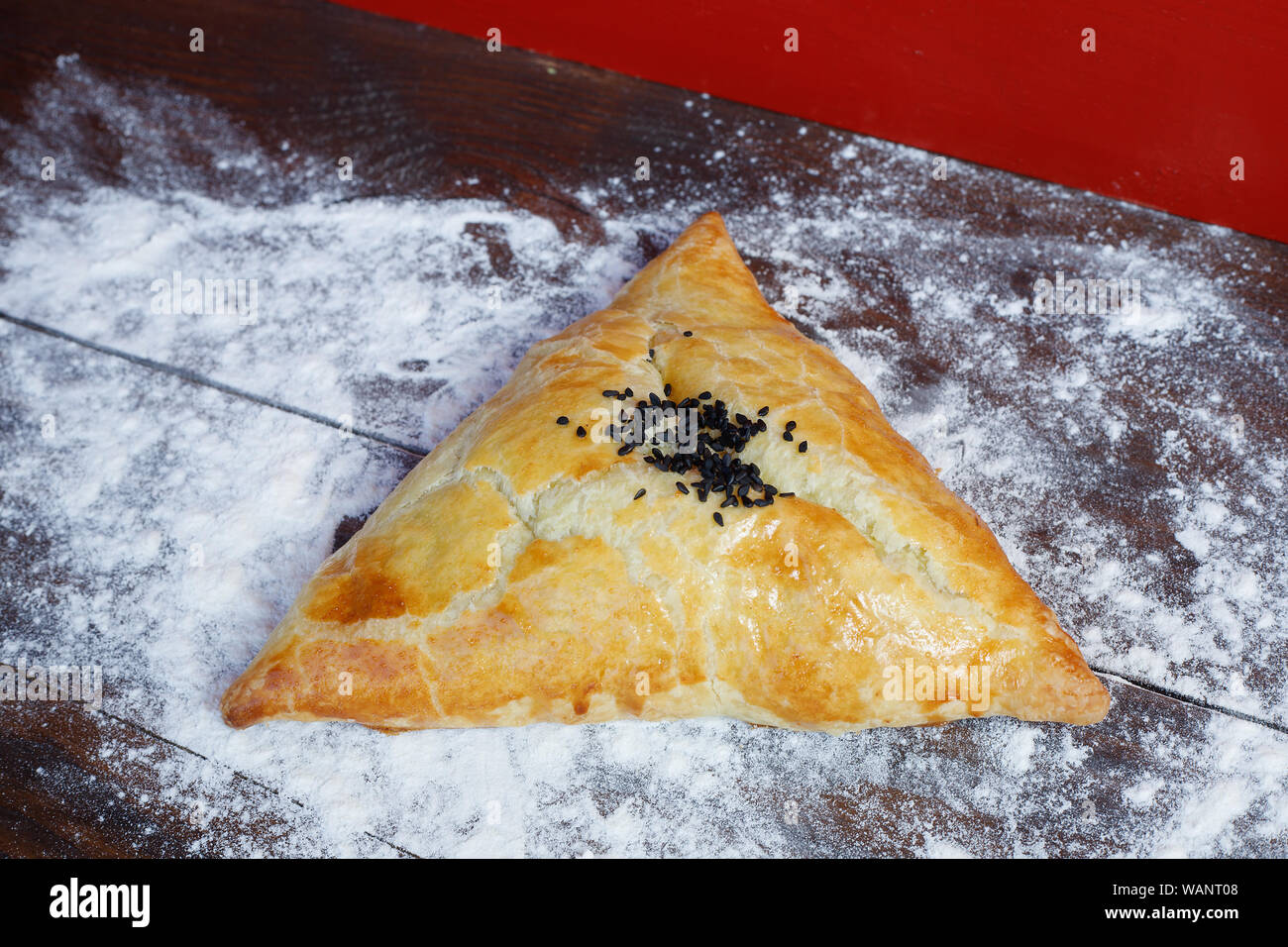 Wooden board with delicious samosas on tableSamsa on a table covered ...