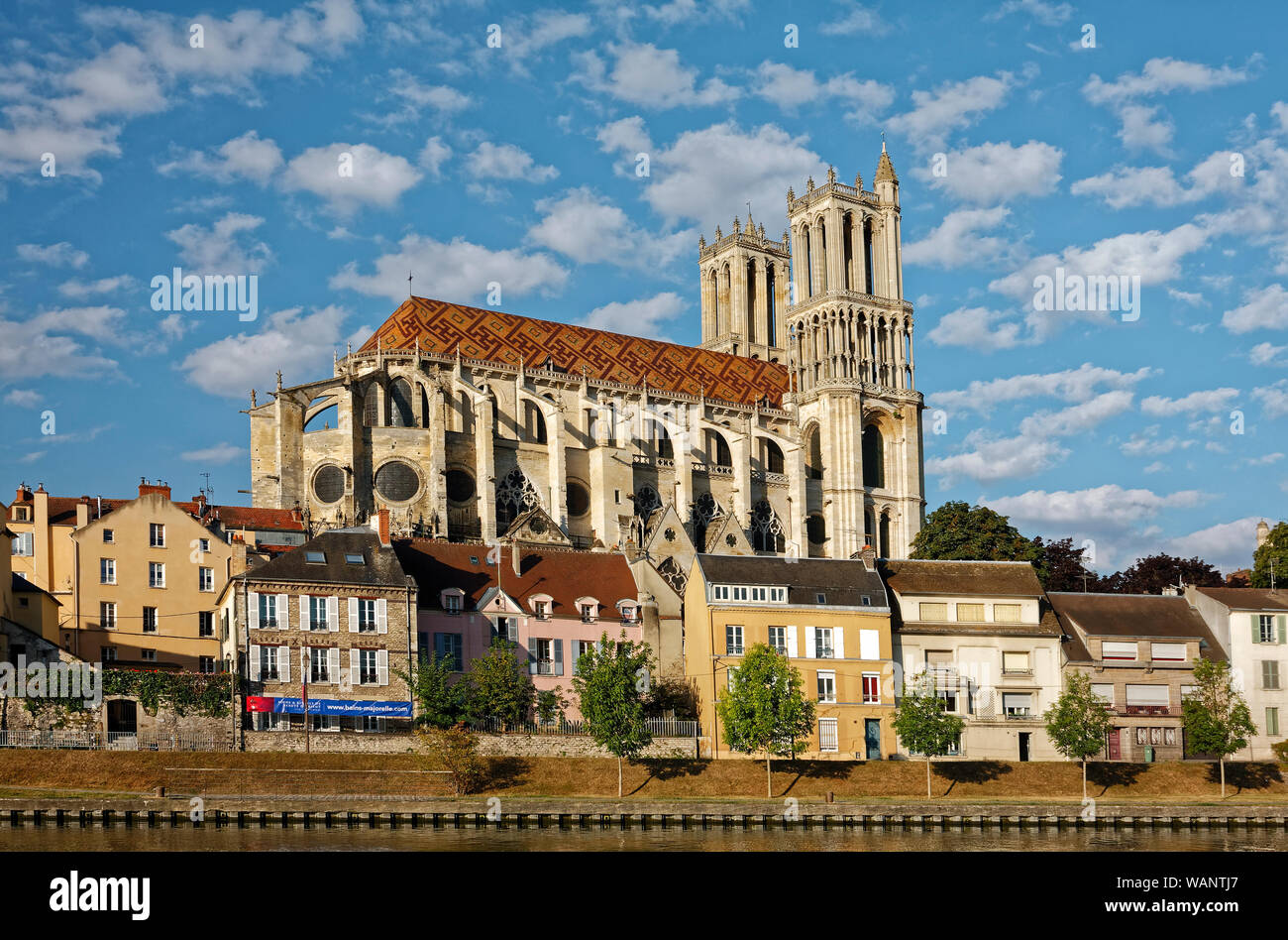Seine River scene; town, large Catholic church, square twin towers ...