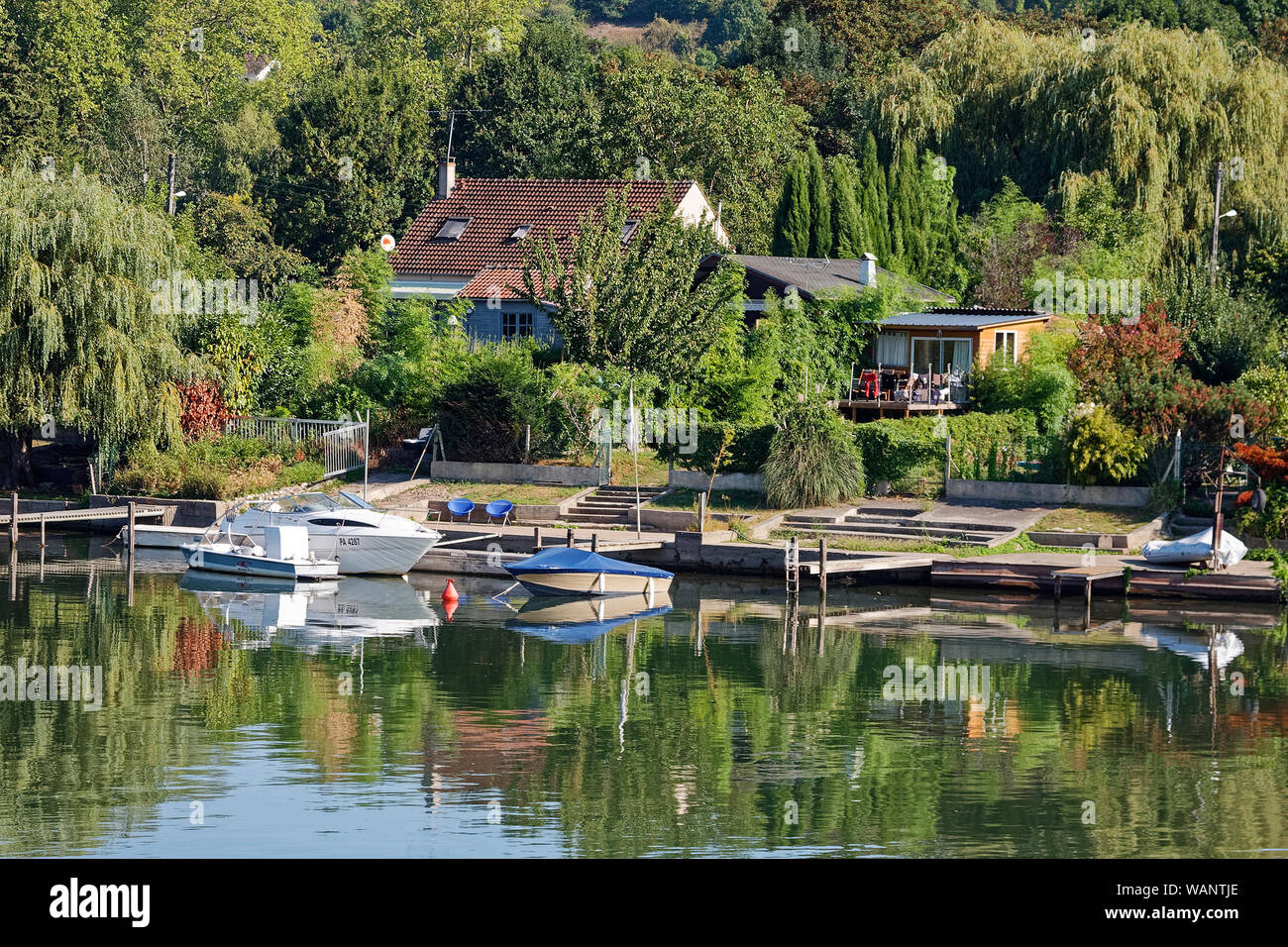Seine River scene; house, 3 sections, old, new, boats, docks, trees ...