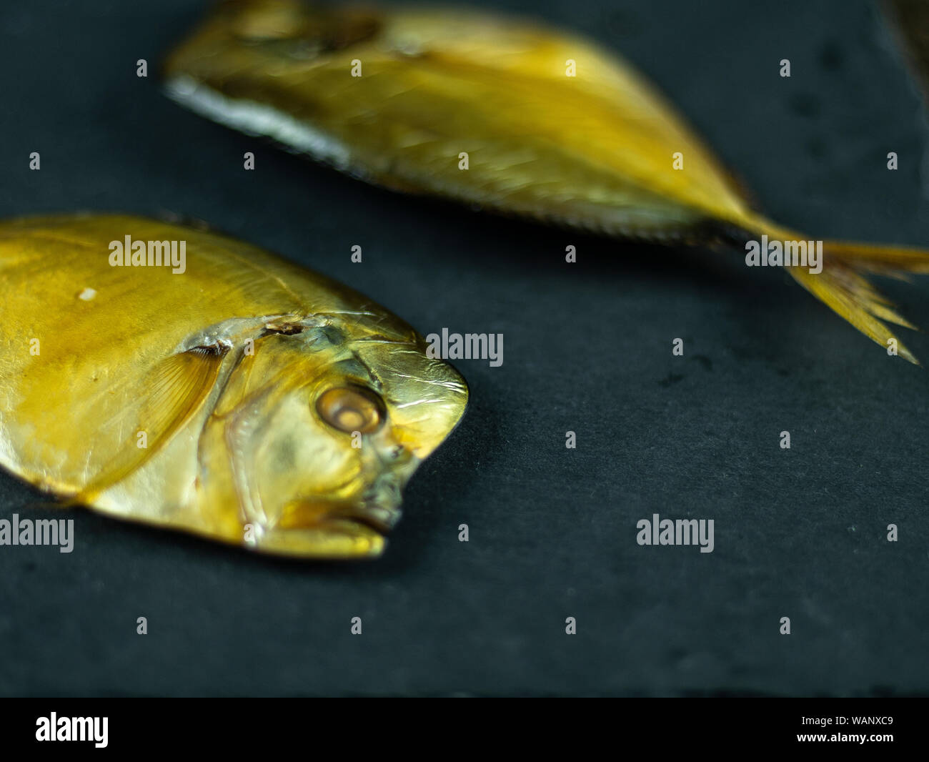 Smoked fish on stone background. Side view Stock Photo - Alamy