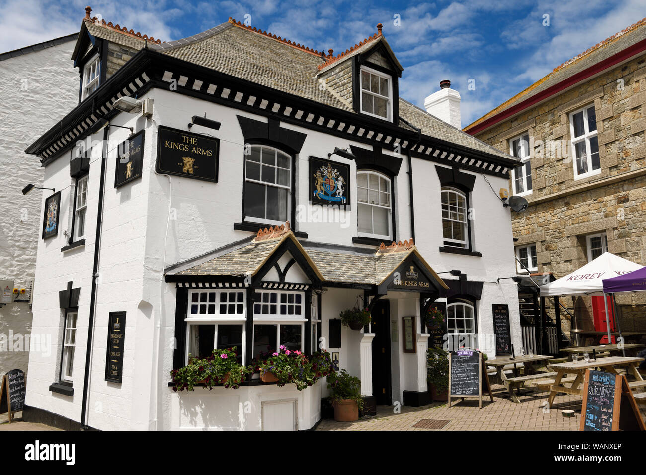 Black and white building of The Kings Arms pub next to the Town Hall ...
