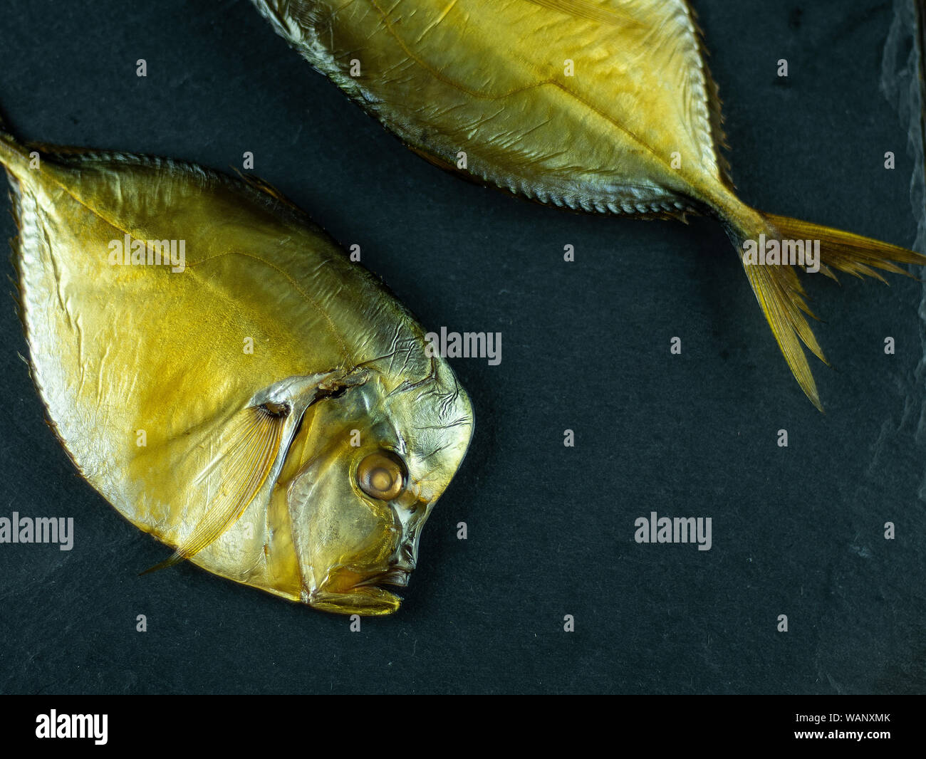 Smoked fish on stone background. Side view Stock Photo - Alamy