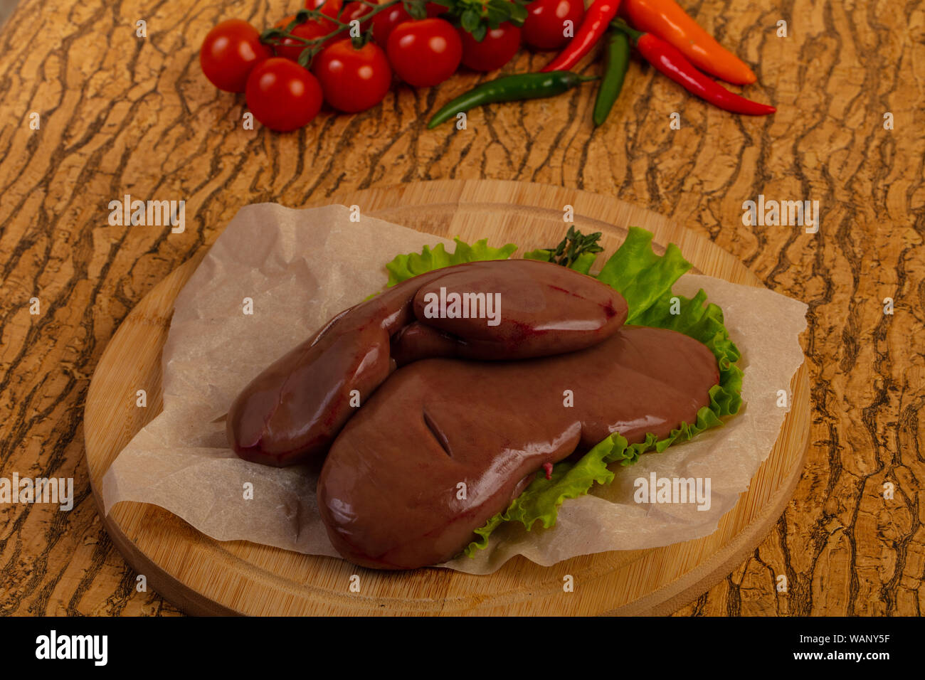 Raw pork kidneys ower wooden background Stock Photo - Alamy