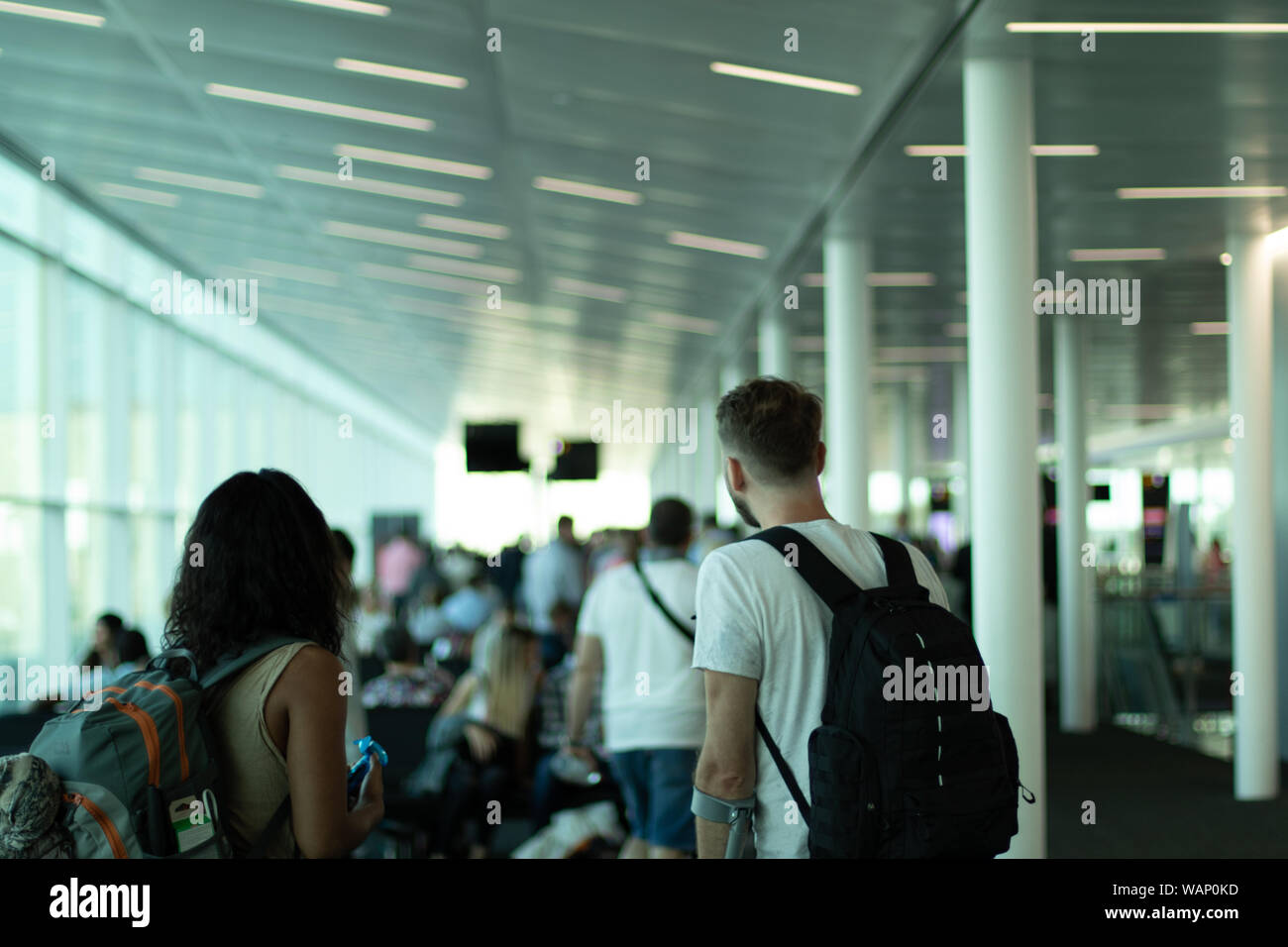 couple waiting at the gate at Stansted airport Stock Photo - Alamy