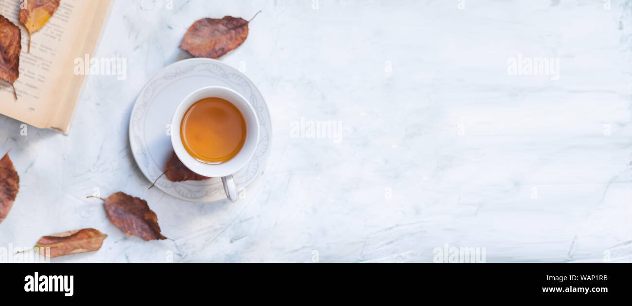 Autumn conceptual background. A cup of hot tea with fall leaves and ...
