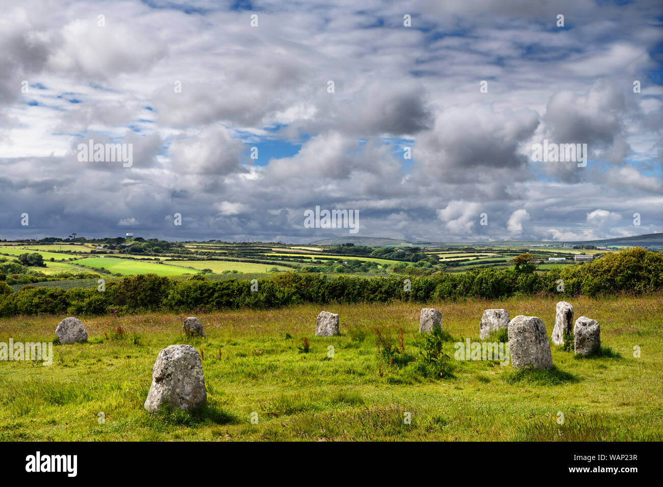 Merry Maidens of Boleigh neolithic stone circle with green farm fields ...