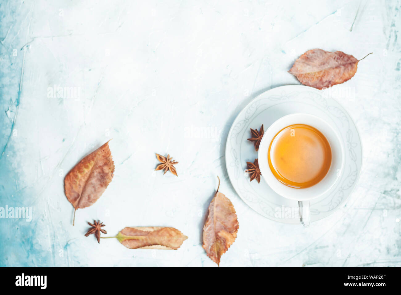 Autumn conceptual background. A cup of hot tea with fall leaves and ...