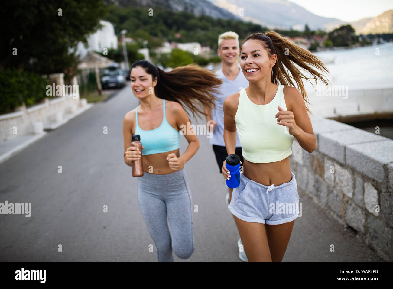 Group of young people friends running outdoors at seaside Stock Photo ...
