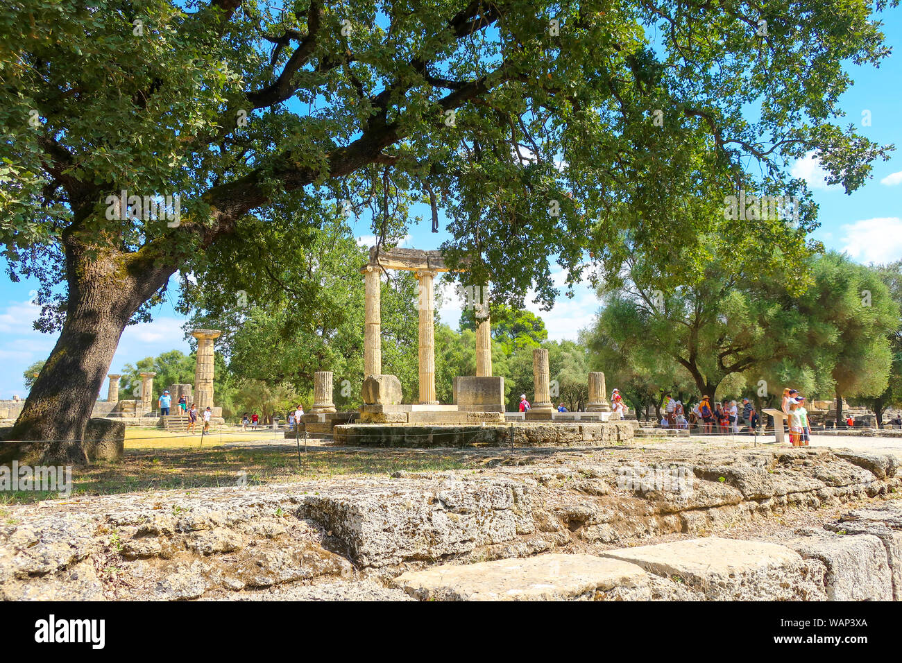 Tourists visit the ancient Philippeion in the Altis of Olympia, an ...