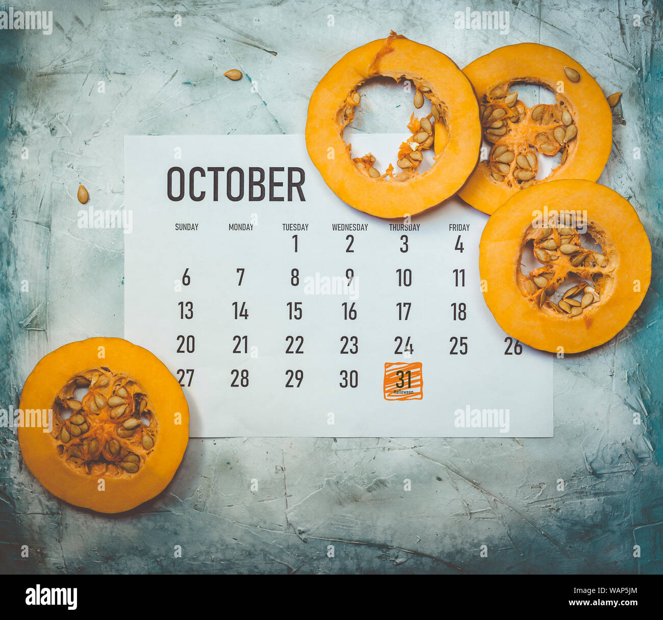 Fall concept. October 2019 Paper Calendar with round slices of pumpkin ...
