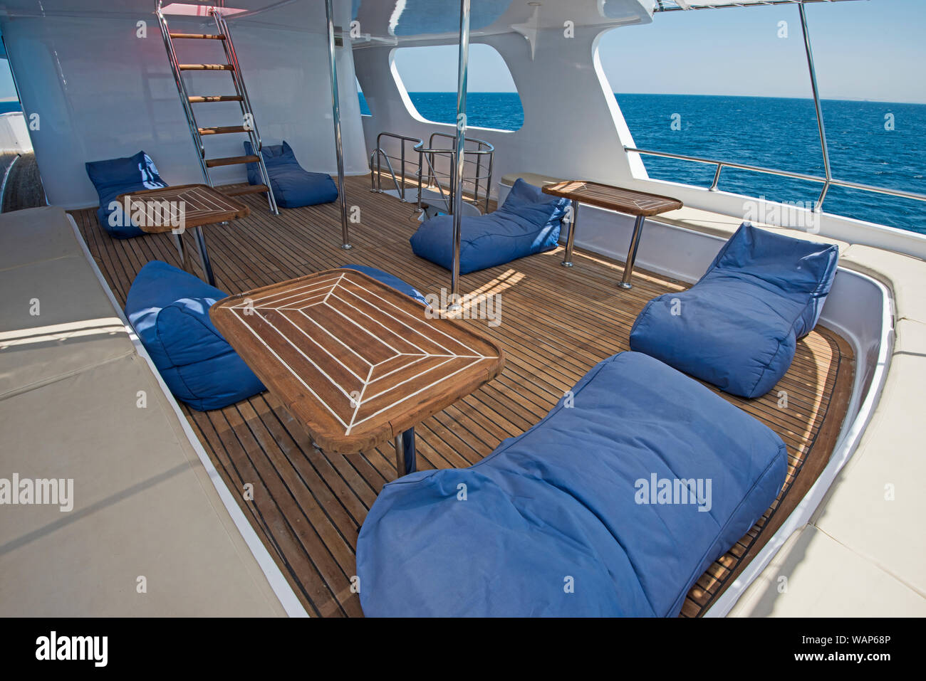 Rear sundeck of a large luxury motor yacht with chairs sofa table and ...