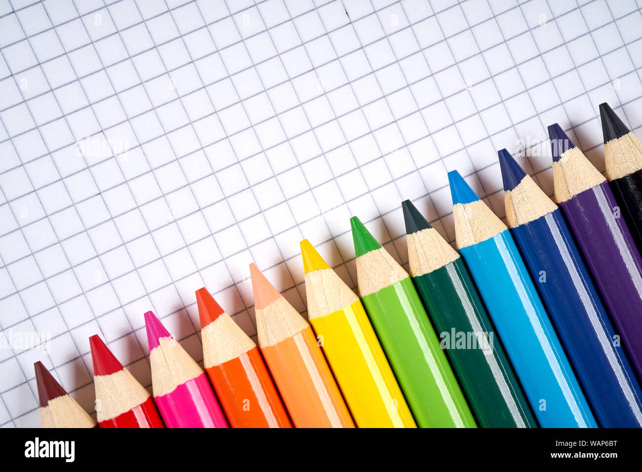 colored pencil crayons on an open checkered notebook Stock Photo - Alamy