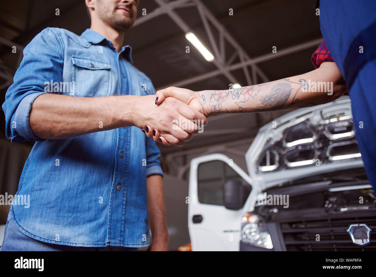 Car owner shakes mechanics hand as the gratefull gesture for the work ...