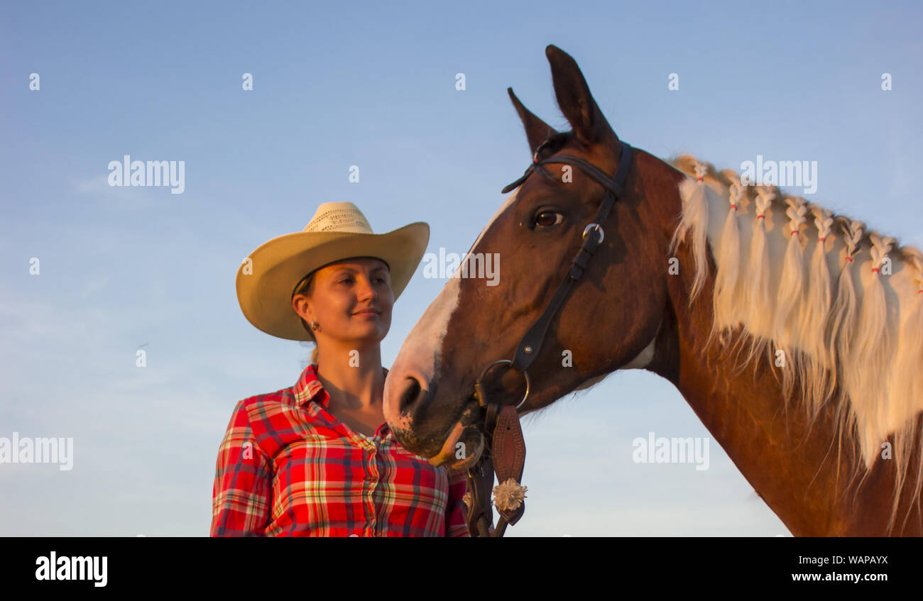 Young girl and her mare with pigtails on mane Stock Photo - Alamy