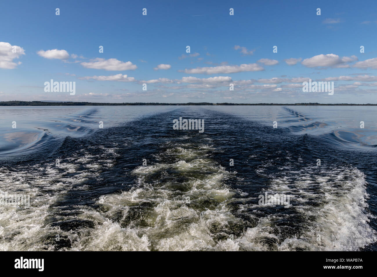 Boat waves, Clouds and reflections in Lough Corrib lake, Cong, Mayo ...