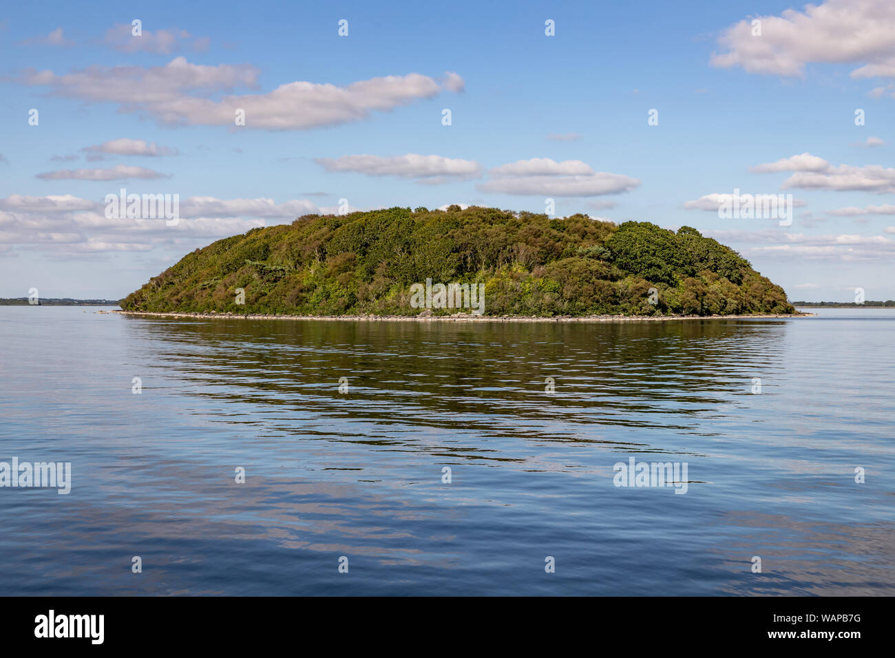 Island, Clouds and reflections in Lough Corrib lake, Cong, Mayo, Irelnd ...