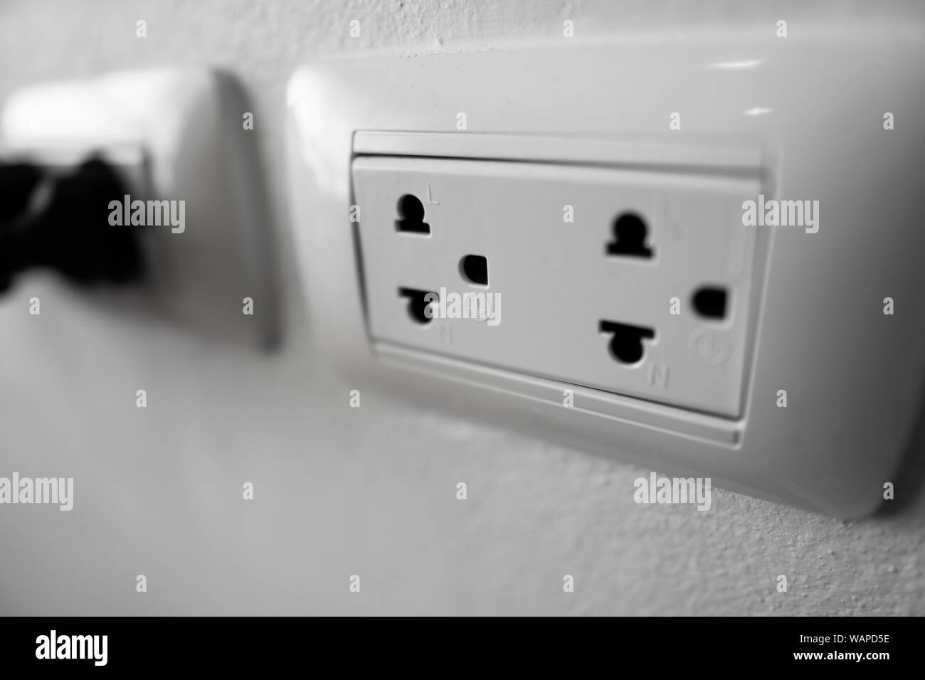 White universal electricity sockets plug on a white wall Stock Photo ...