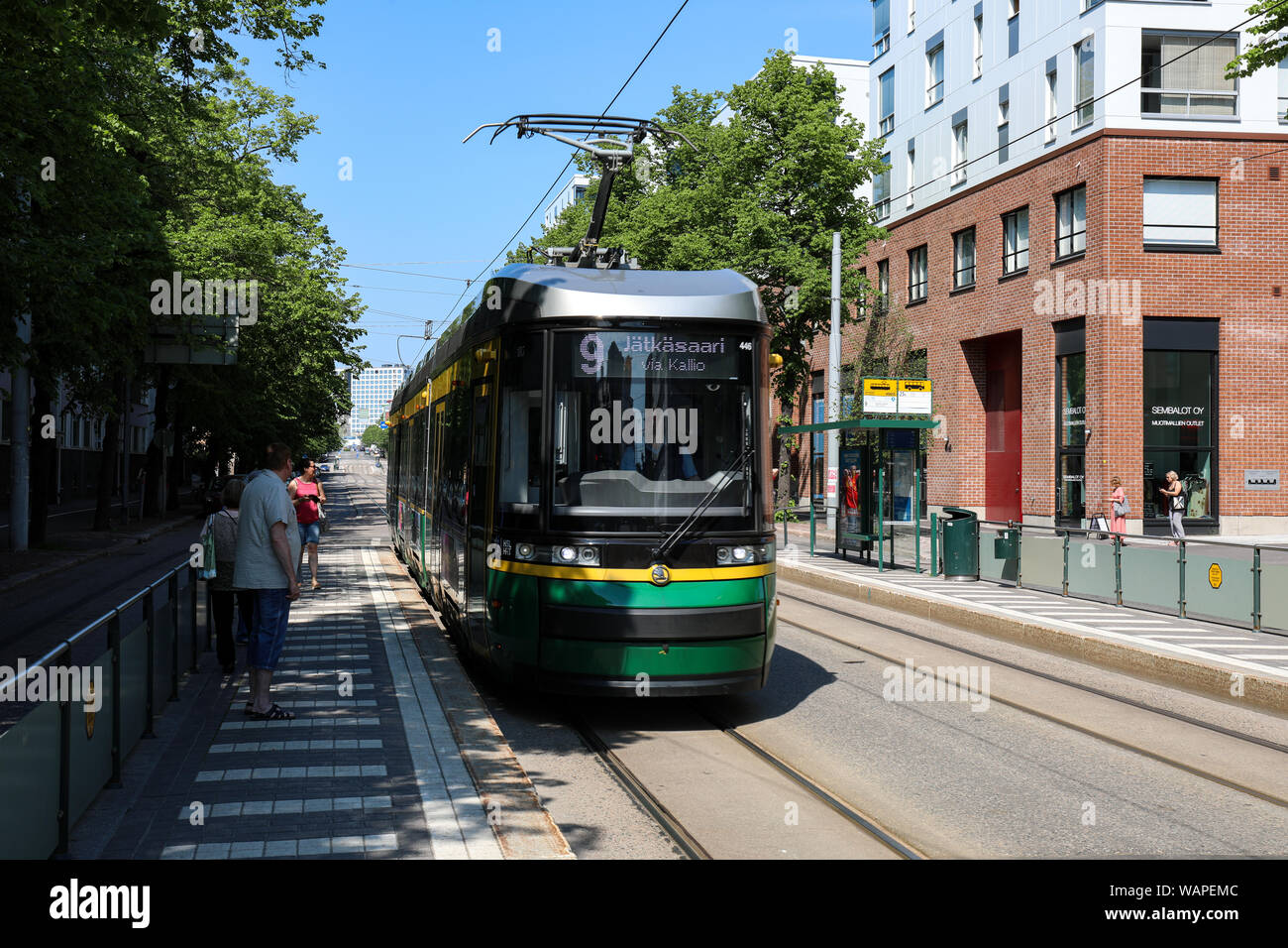 Tram 9 arrives to tram stop in Aleksis Kiven katu -newly built Konepaja ...