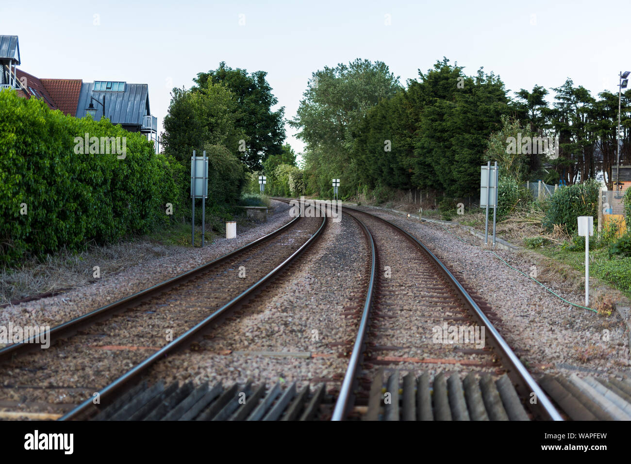 An empty train track, there are 2 tracks leading to a point on the ...