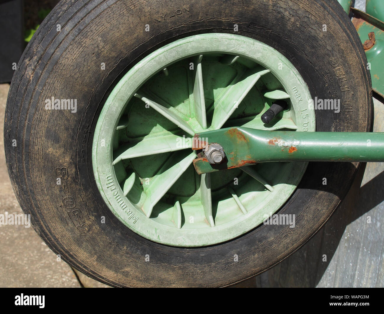 A close up view of a garden wheelbarrow wheel with an inflatable tyre ...