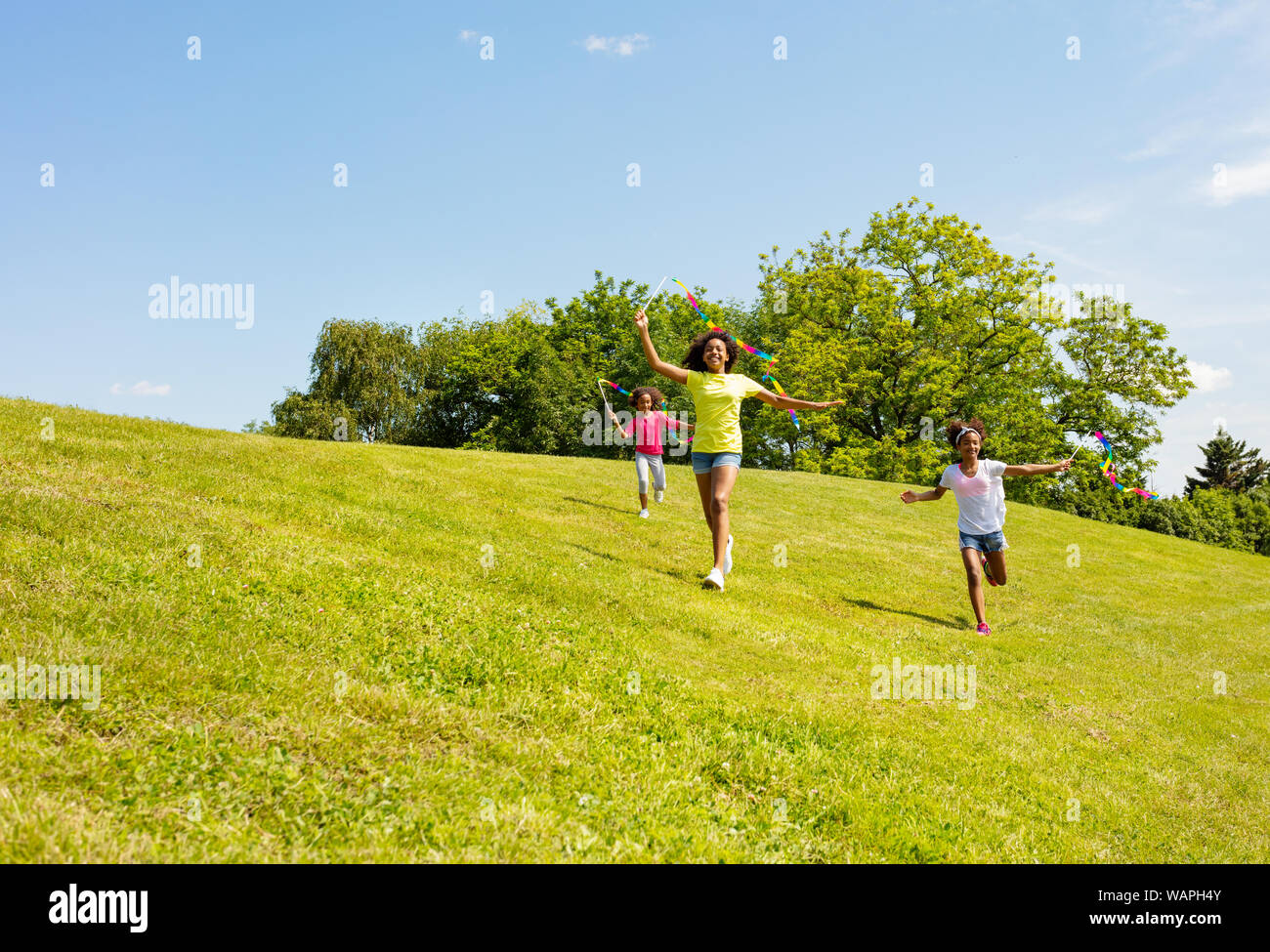 Group of kids run with ribbon to camera in park Stock Photo - Alamy