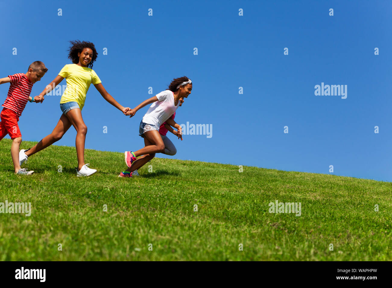 Diverse group of happy fast running children Stock Photo - Alamy