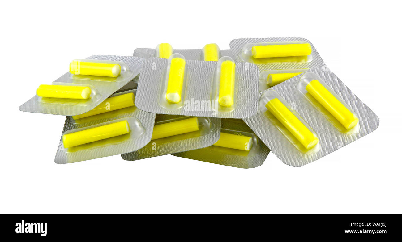 Yellow pills in blister on white background. Pharmaceutical drugs for ...