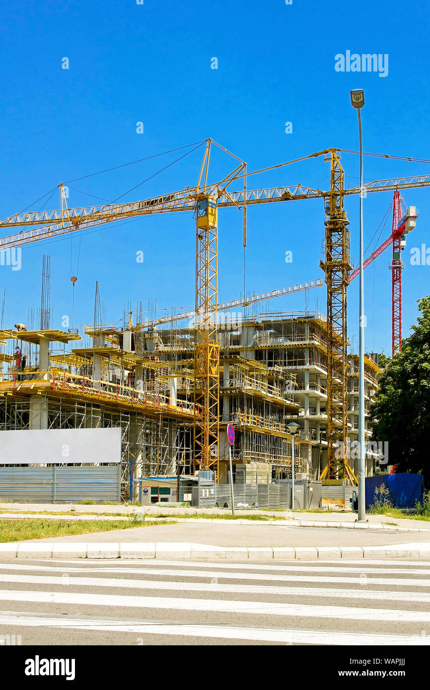 Big building construction site with several cranes Stock Photo - Alamy