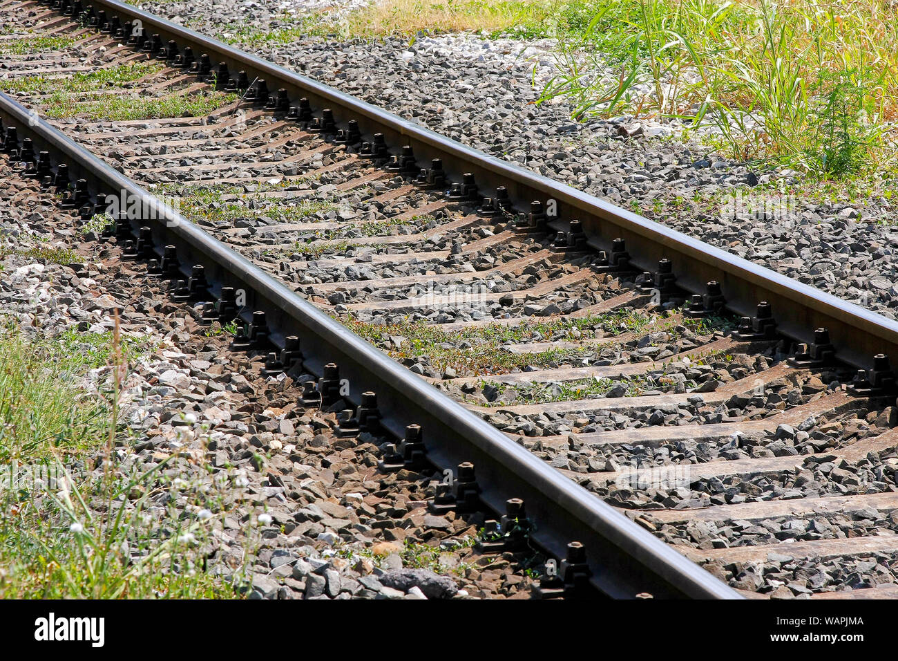 Close up shot of diagonal rail tracks Stock Photo - Alamy