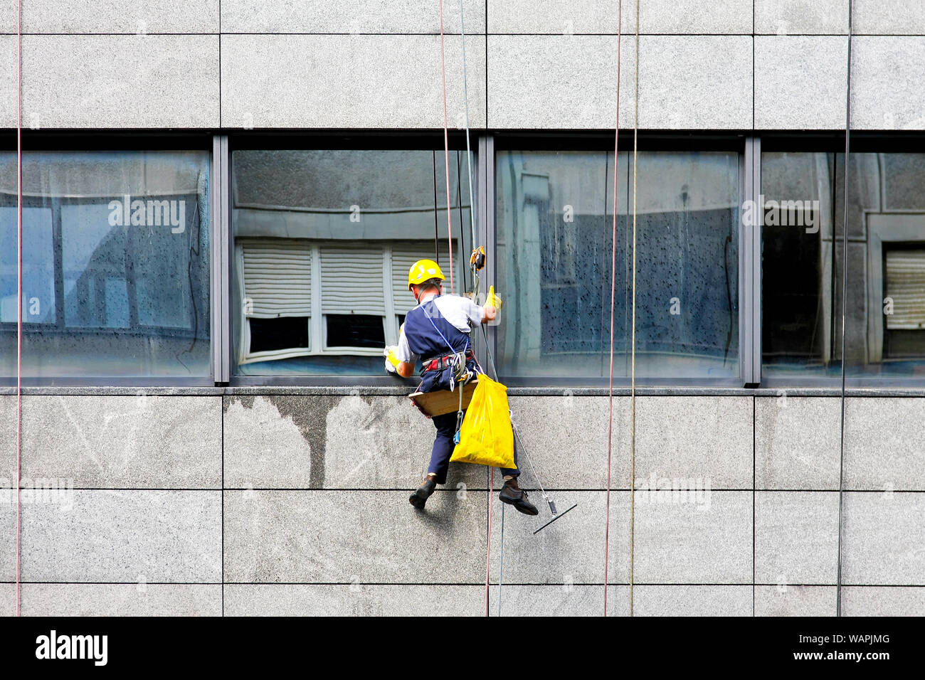 Windows cleaner at danger and risky work Stock Photo - Alamy