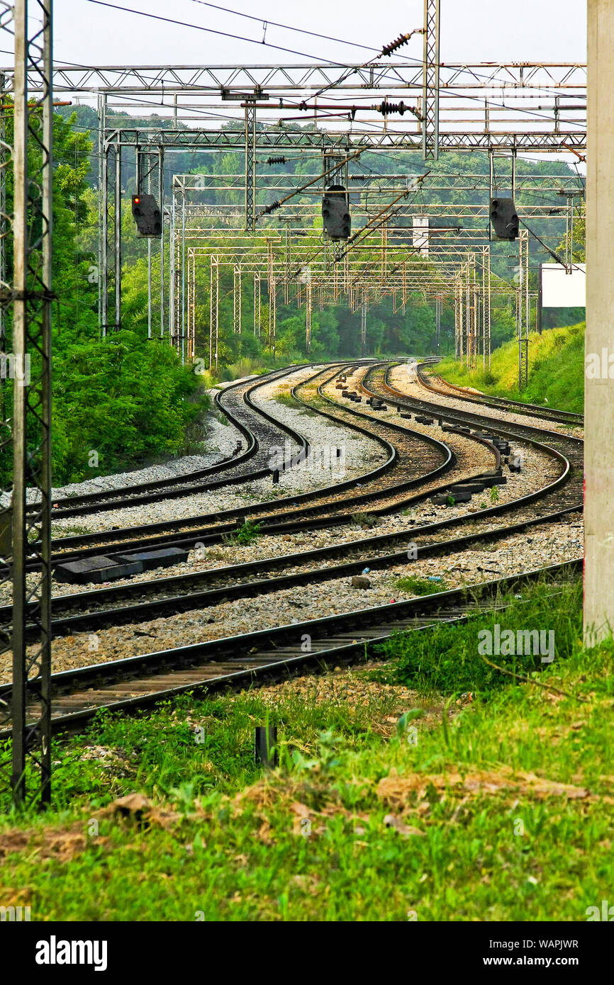 Four lane railroad with double curve tracks Stock Photo - Alamy