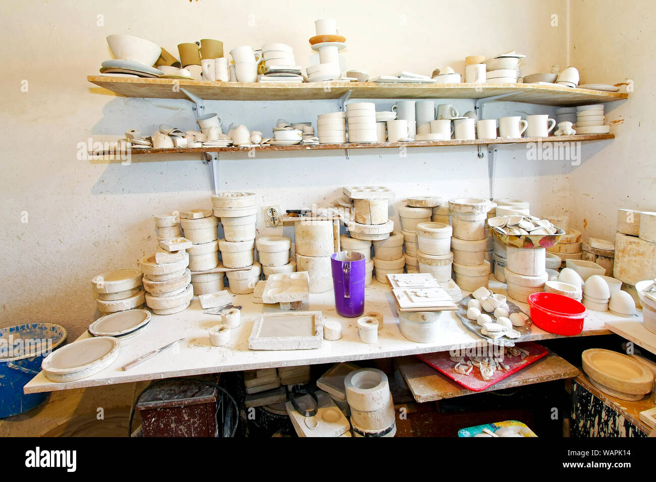 Ceramic production work bench with blank pottery Stock Photo - Alamy