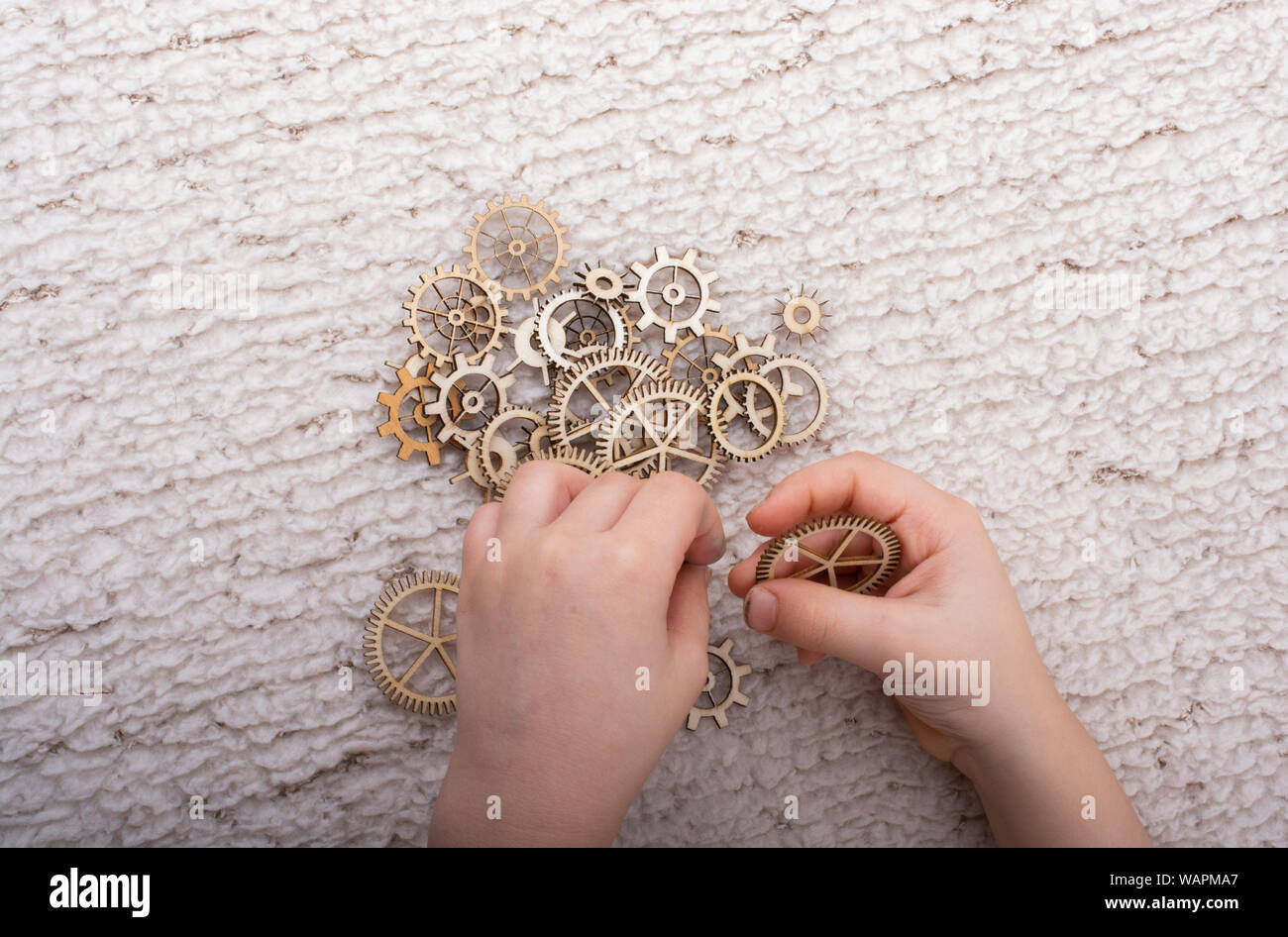 Hand holding gear wheels as the concept of mechanism Stock Photo - Alamy