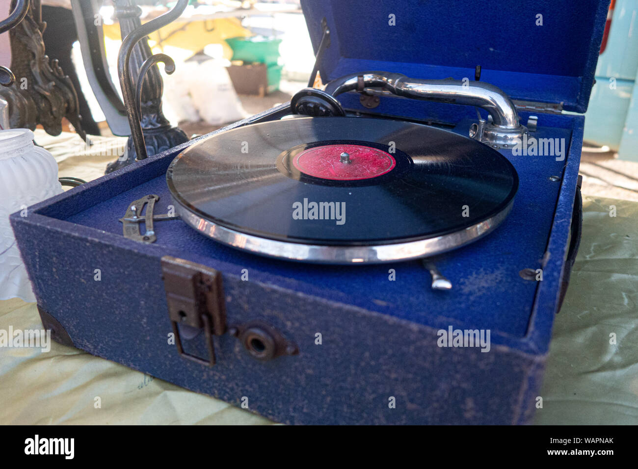 Vintage aged turntable with old vinyl record on street market stall ...