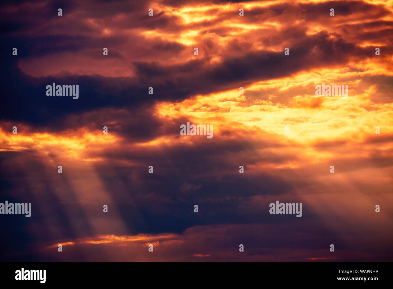 Colorful sky with dark clouds and sun rays Stock Photo - Alamy
