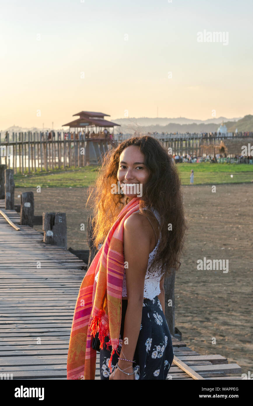 Vertical picture of foreigner tourist model showing hapiness at U Bein ...