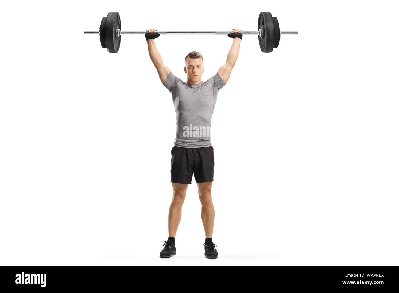 Full length portrait of a young muscular guy lifting weights isolated ...