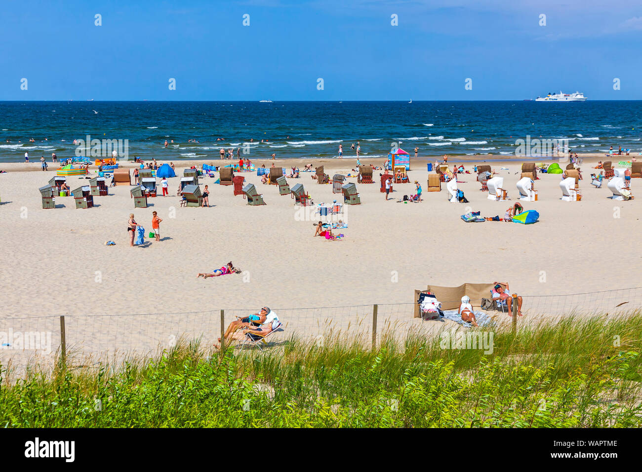 People relax on a crowded Baltic sea beach on Usedom island in ...