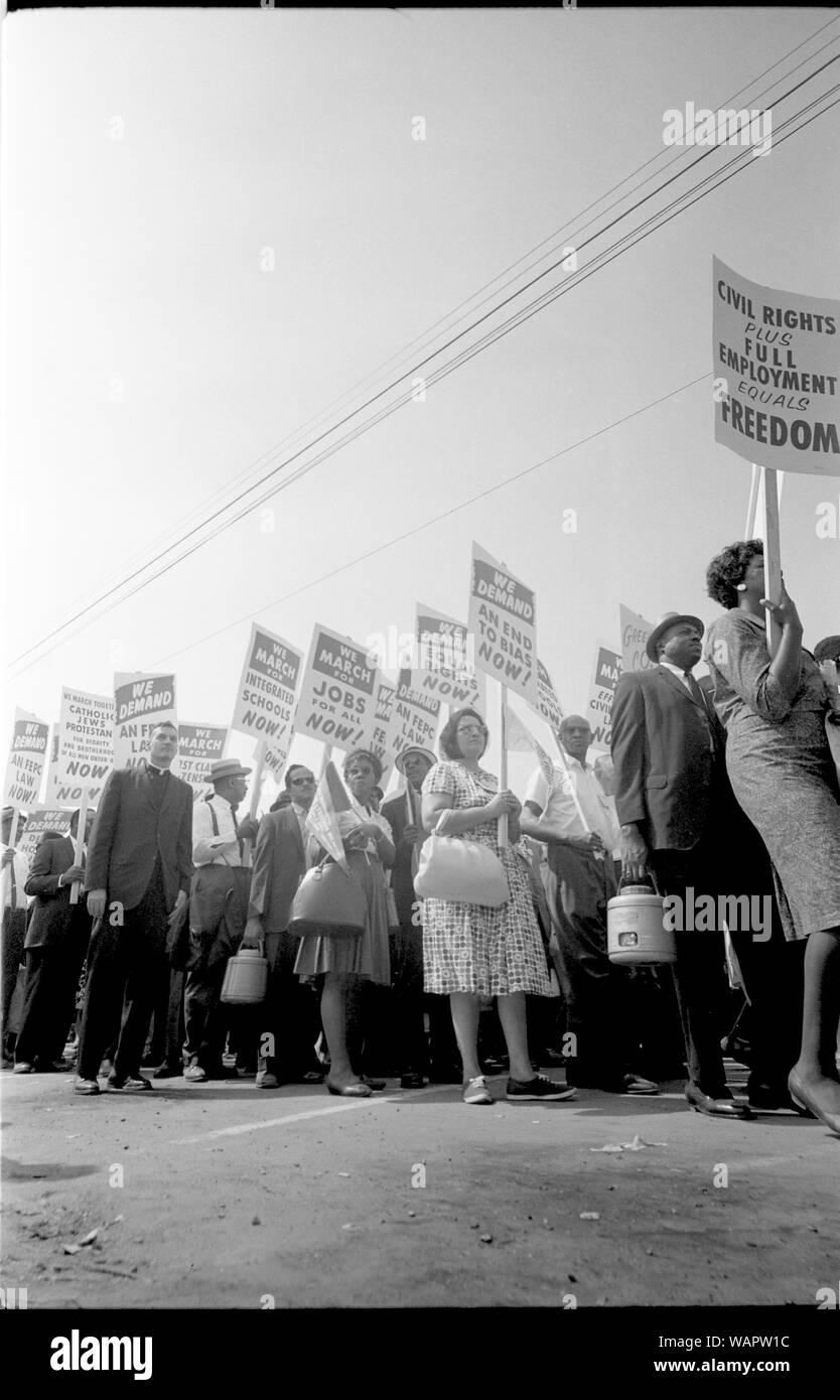 [Demonstrators marching in the street holding signs during the March on ...