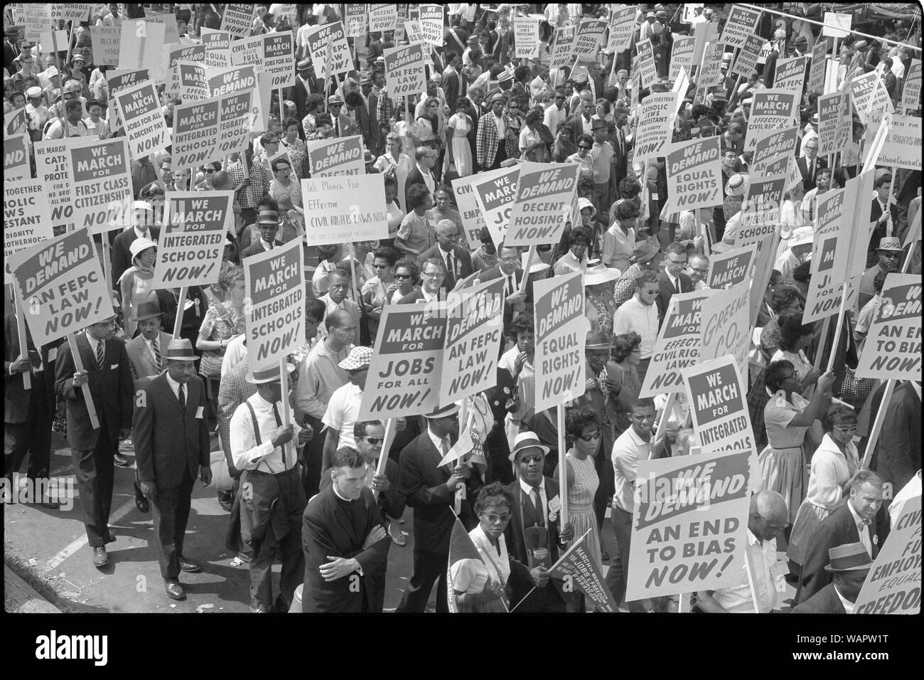 Demonstrators Marching In The Street Holding Signs During The March On
