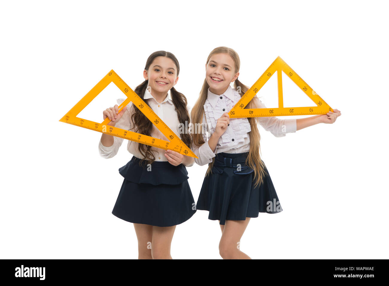 Our geometry lesson for the day. Cute schoolgirls holding triangular ...