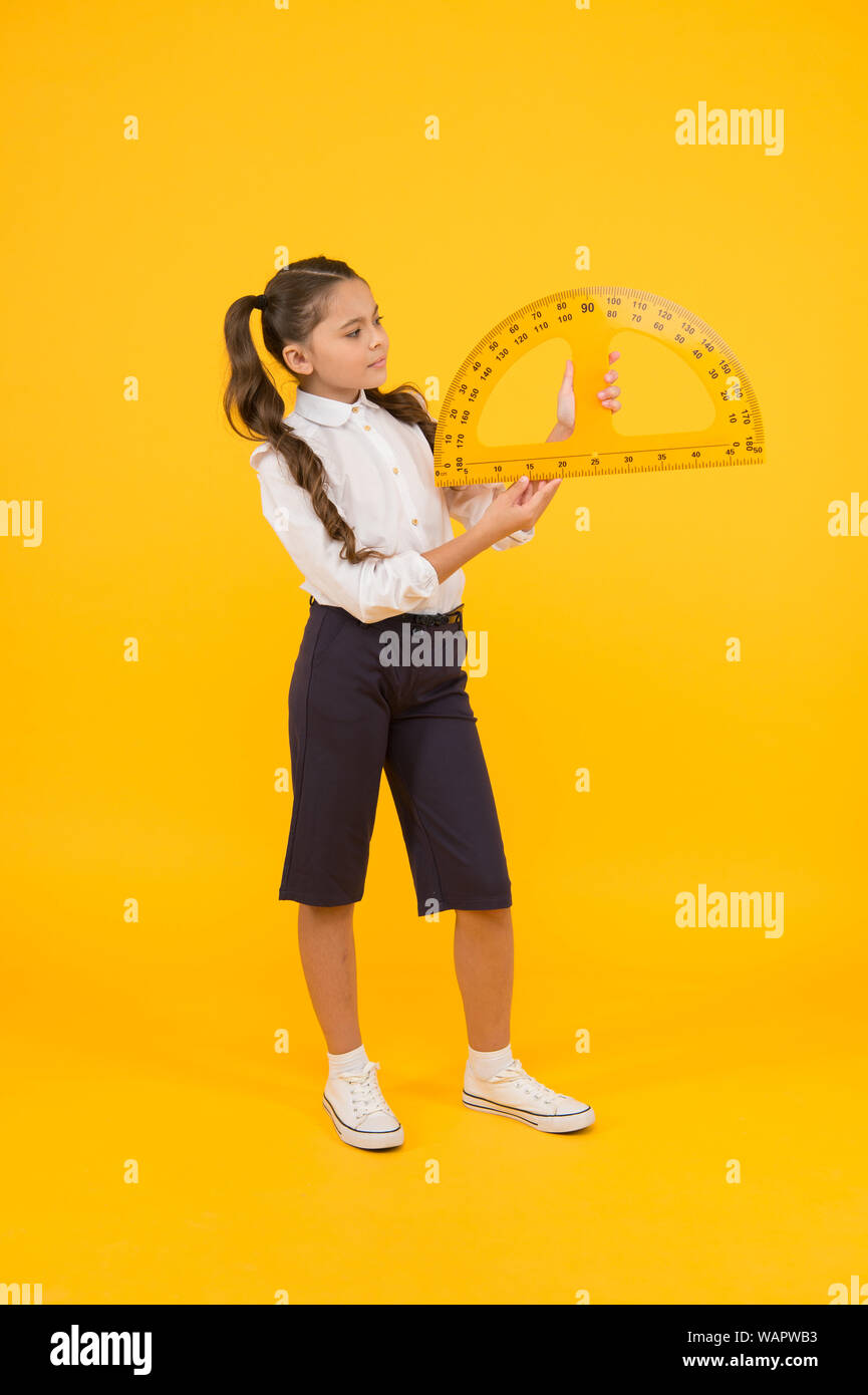 Setting square with protractor. Little girl using triangle to measure ...