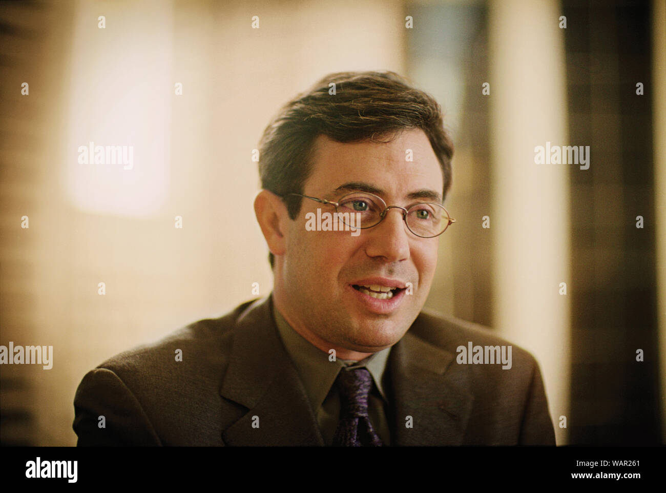 Mid adult business man speaking Stock Photo - Alamy