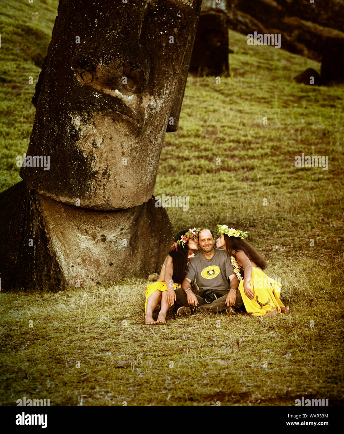 Jim getting kissed by two girls on Easter Island Stock Photo - Alamy