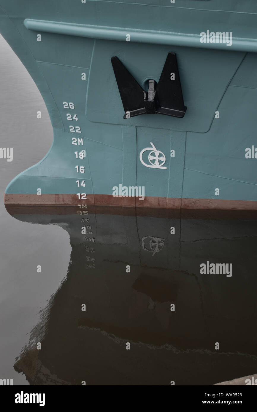 Draft marks on bow of stationery ship with blue painted hull and black ...
