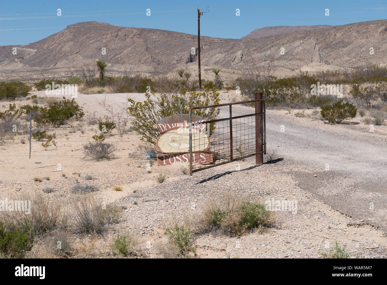 Dilapidated sign and gate announcing Badlands Fossils stand along the ...