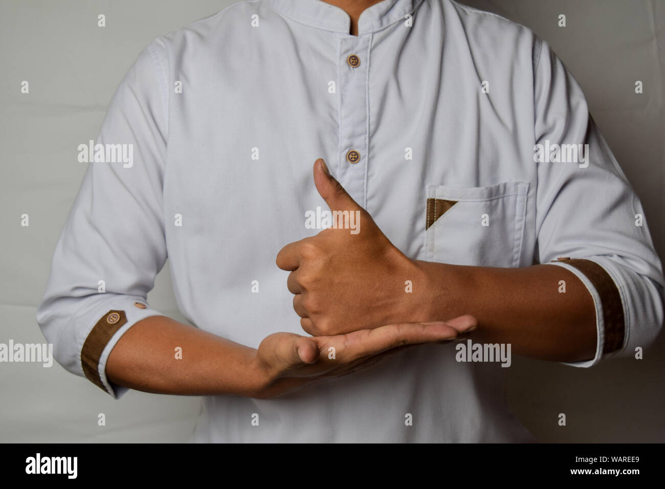 Close up Asian man shows hand gestures it means HELP isolated on white ...