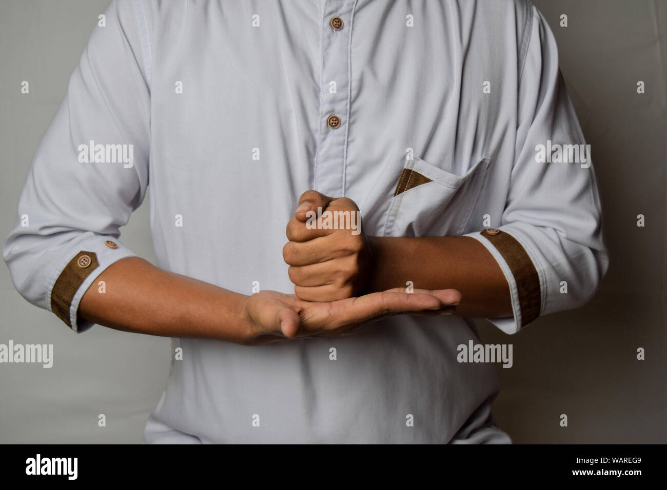 Close up Asian man shows hand gestures it means HELP isolated on white ...