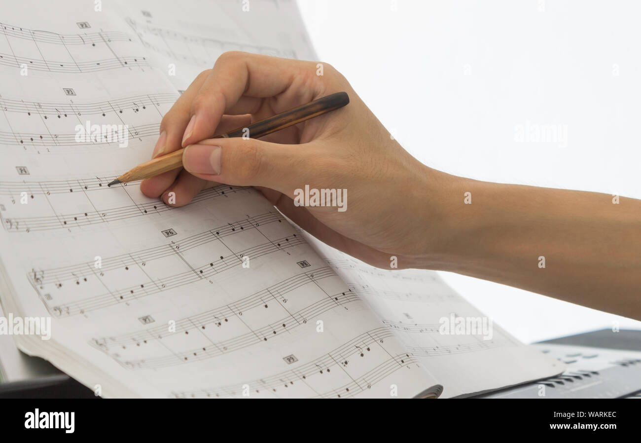 Hand of Piano Player is Writing Notes on Piano Staff or Sheet Music by ...