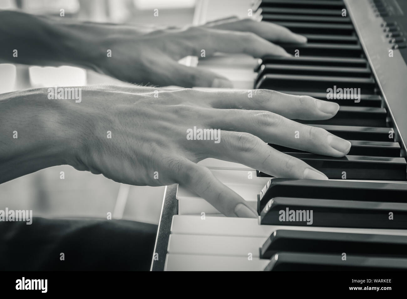 Hand of Piano Player on White Keys and Black Keys of Electric Piano in ...